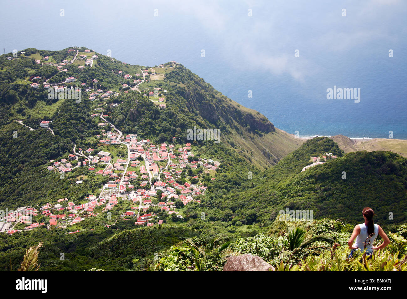 Woman climbing up Saba volcano Mt.Scenery and enjoying it's view over ...