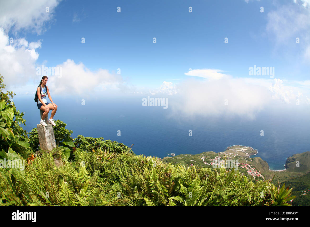 Woman climbing up Saba volcano Mt.Scenery and enjoying it's view over ...