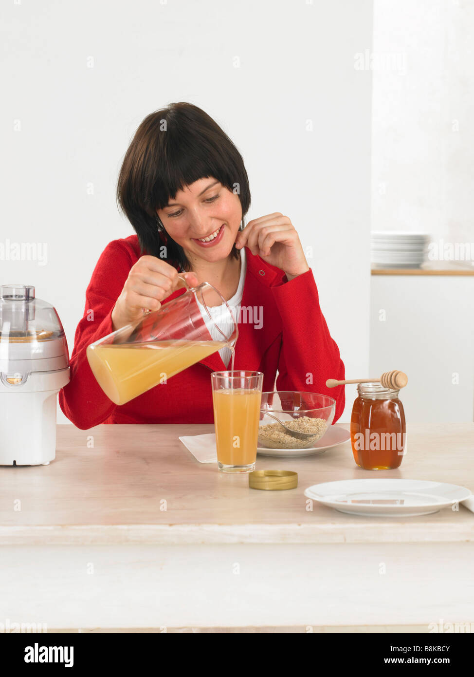 Woman drinking red juice indoor hi-res stock photography and images - Alamy