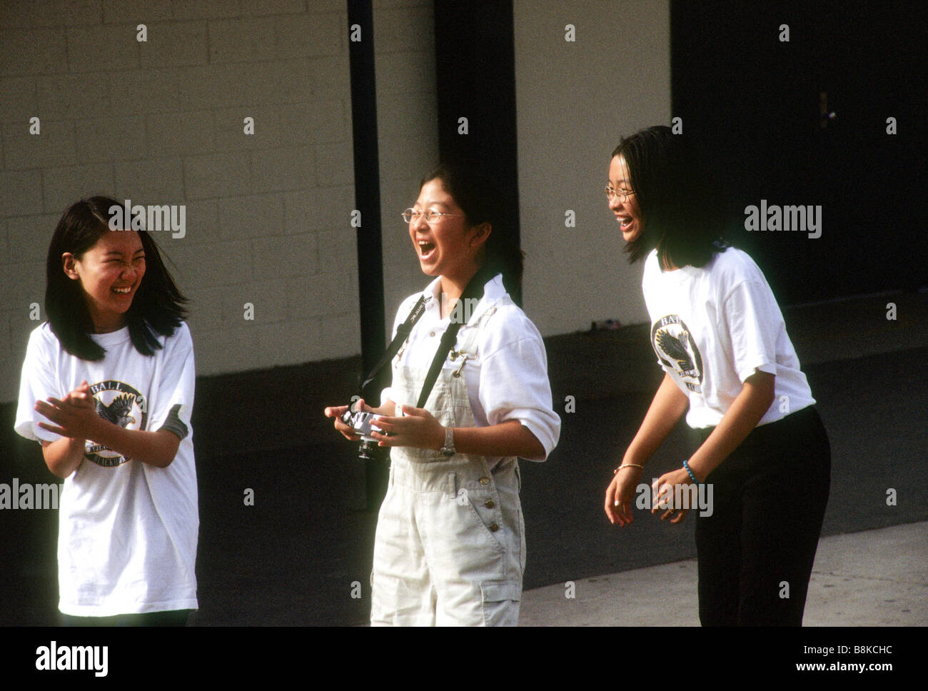 three Asian-American girl laugh take photo picture camera fun fun share ...
