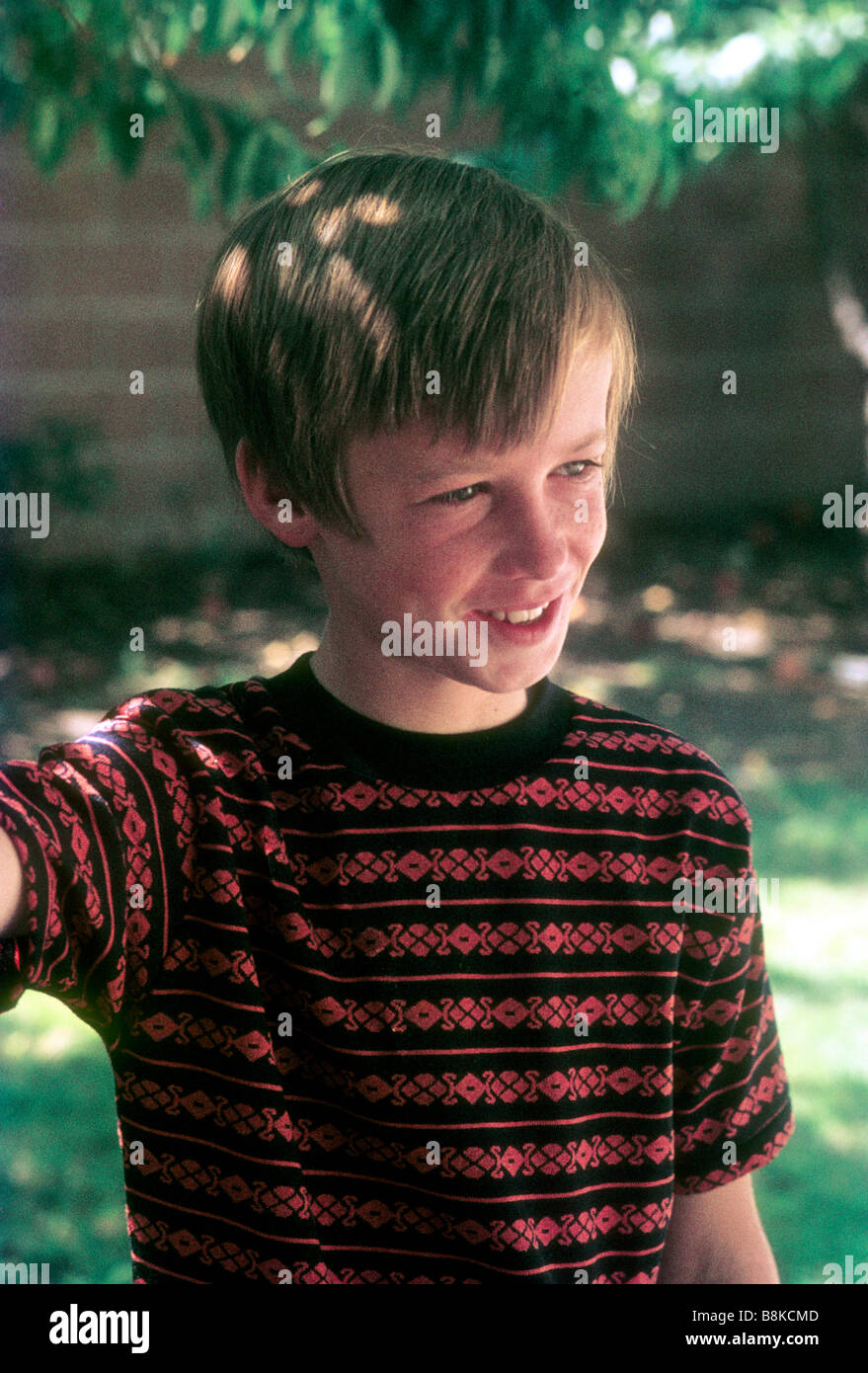 boy serious face direct look stare portrait window intent sad smile ...