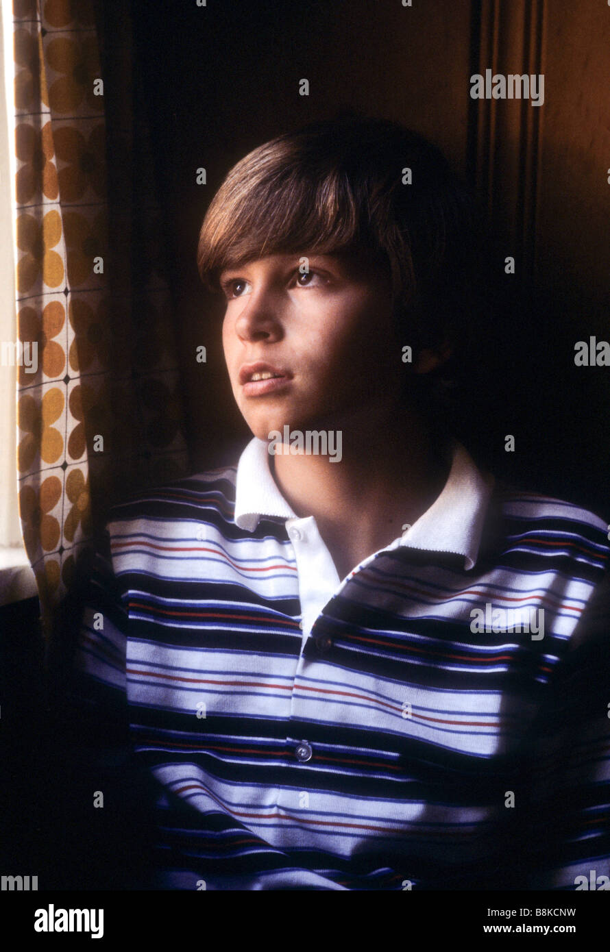 boy serious face direct look stare portrait window intent sad angry mad ...