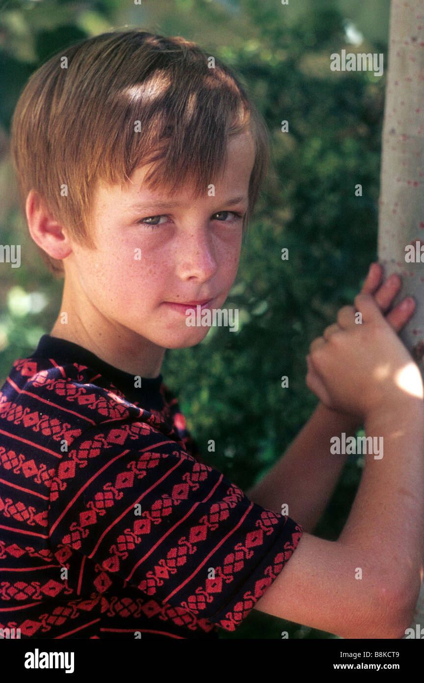 boy serious face direct look stare portrait window intent sad angry mad ...