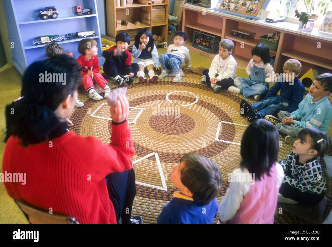 teacher read kindergarten class story share interest listen intent ...