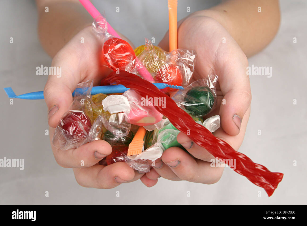 child's hands filled with candy Stock Photo - Alamy