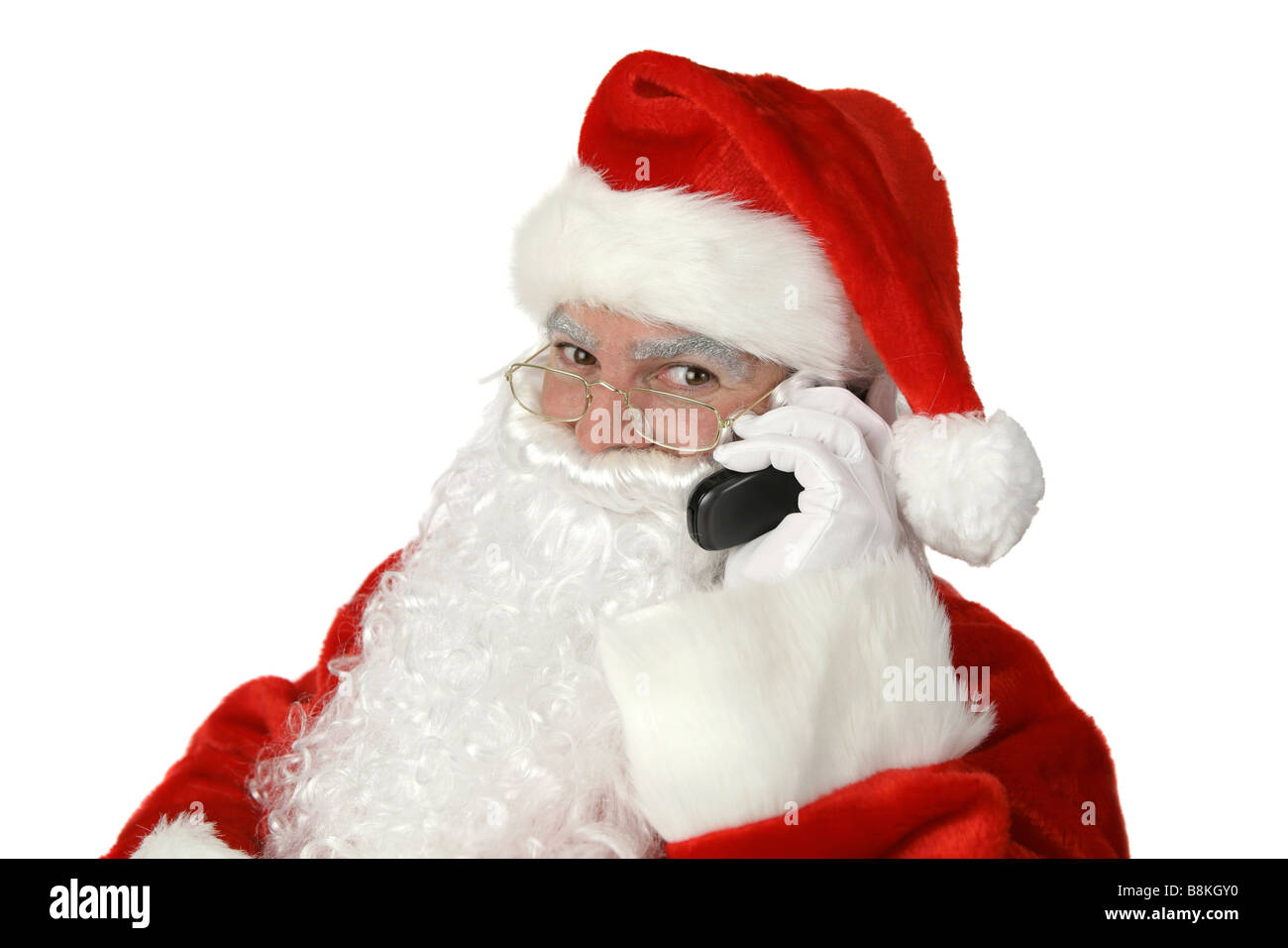 A traditional Christmas Santa Claus talking on a cell phone Isolated on ...