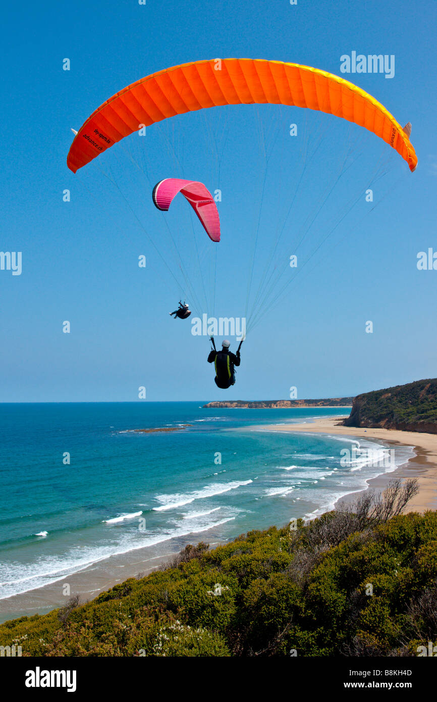 A Paraglider gliding over the famous Cliffs of Bells beach Torquay ...