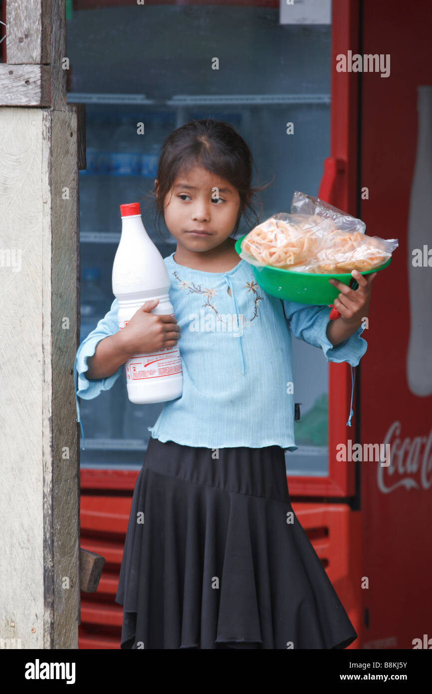 Little mexican girl holding food in both hands Stock Photo - Alamy