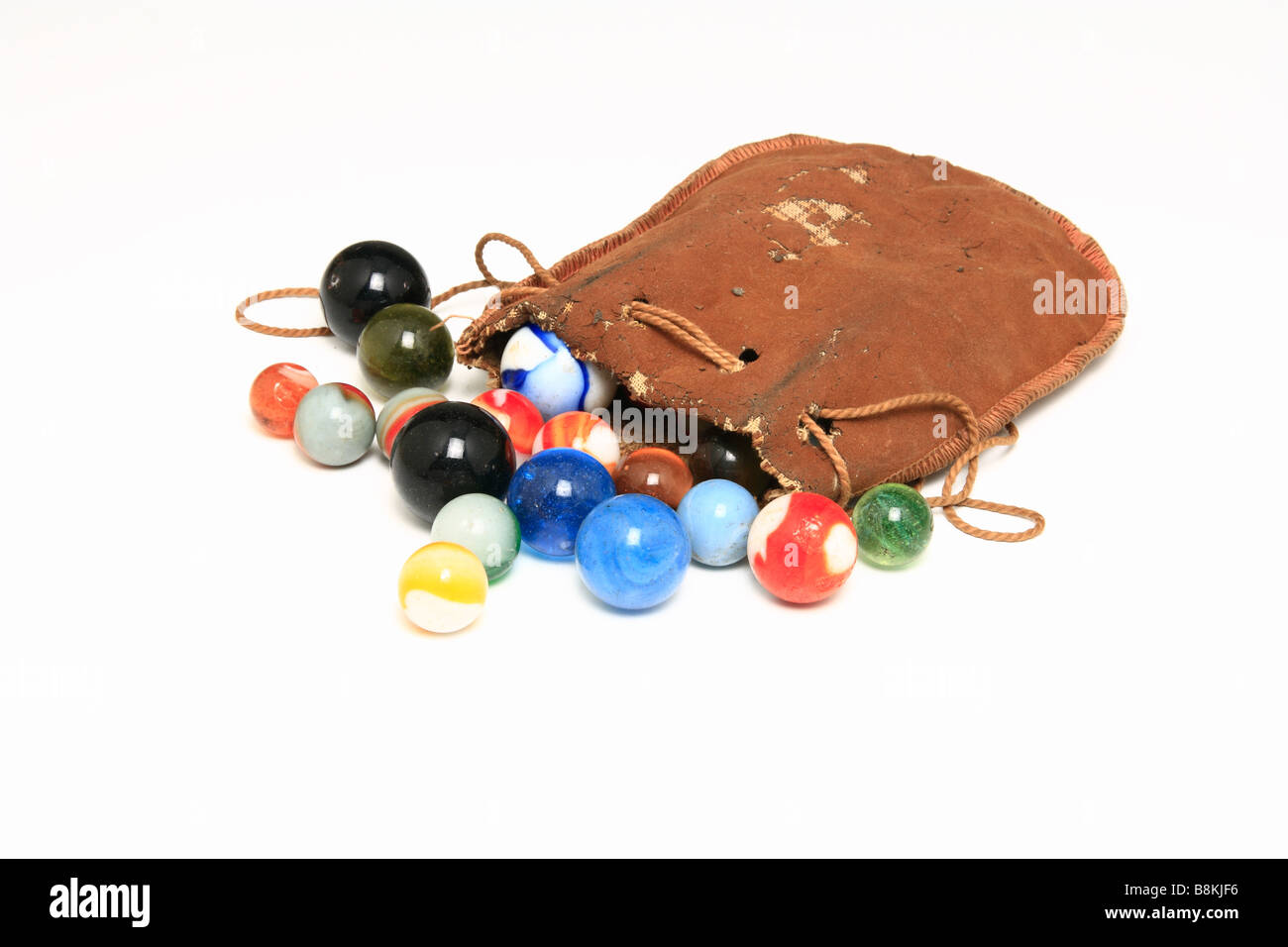 Collection of marbles spilt from a weathered leather pouch Stock Photo ...