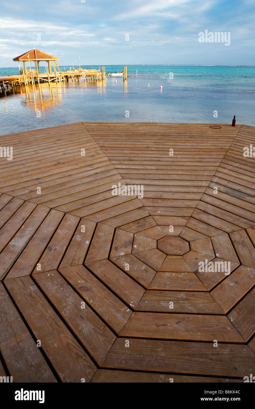New circular pier and hut at sunset on the water on Ambergris Caye in ...