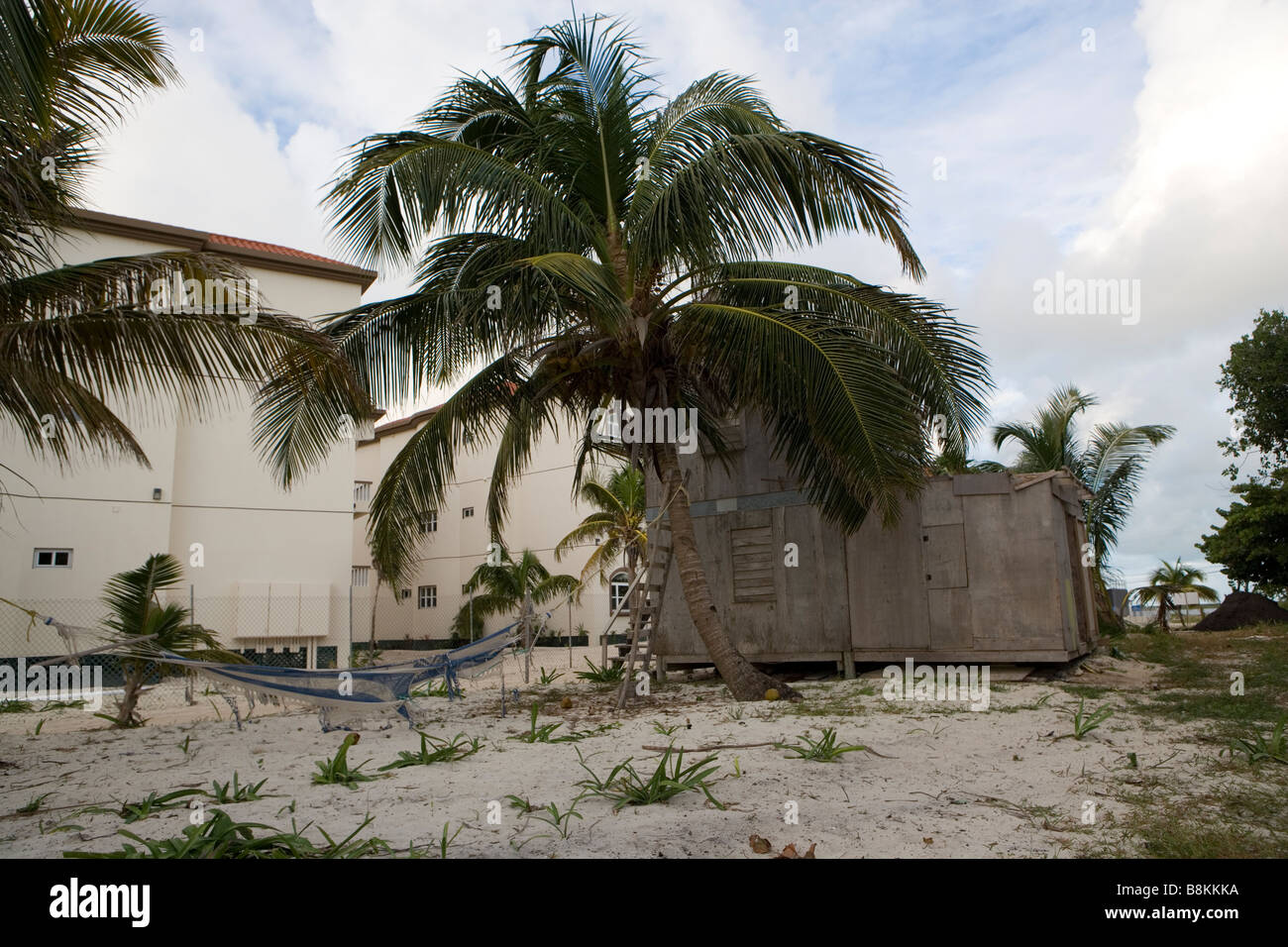 A small wooden shack next to a new building on the beach on Ambergris ...