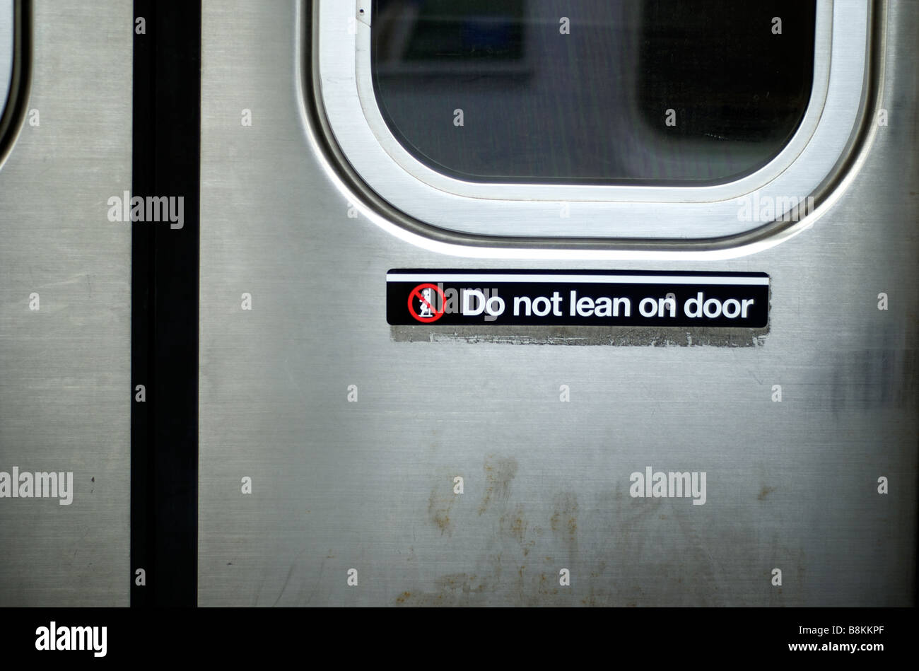 Detail of Dirty New York City Subway Door with sign "Do Not Lean On ...