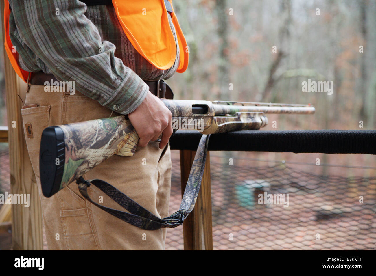 SPORTING CLAY SHOOTER RESTING HIS GUN ON THE RAIL GEORGIA Stock Photo ...