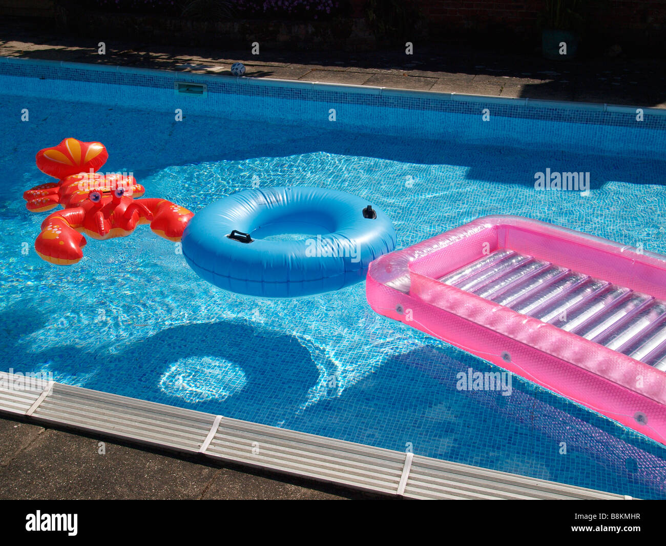 Inflatable objects in a swimming pool Stock Photo - Alamy