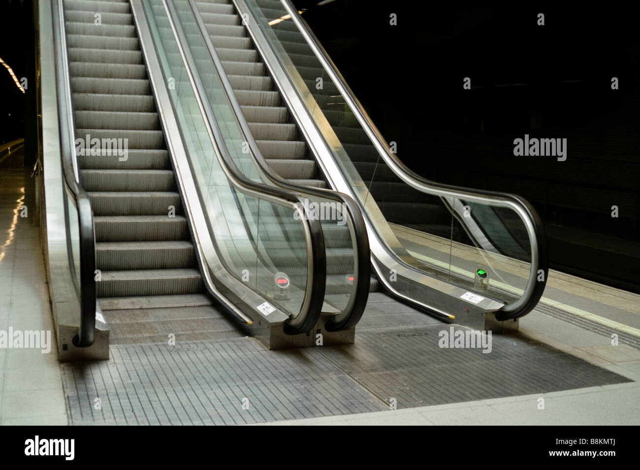 Detail of escalator steps against dark background Stock Photo - Alamy