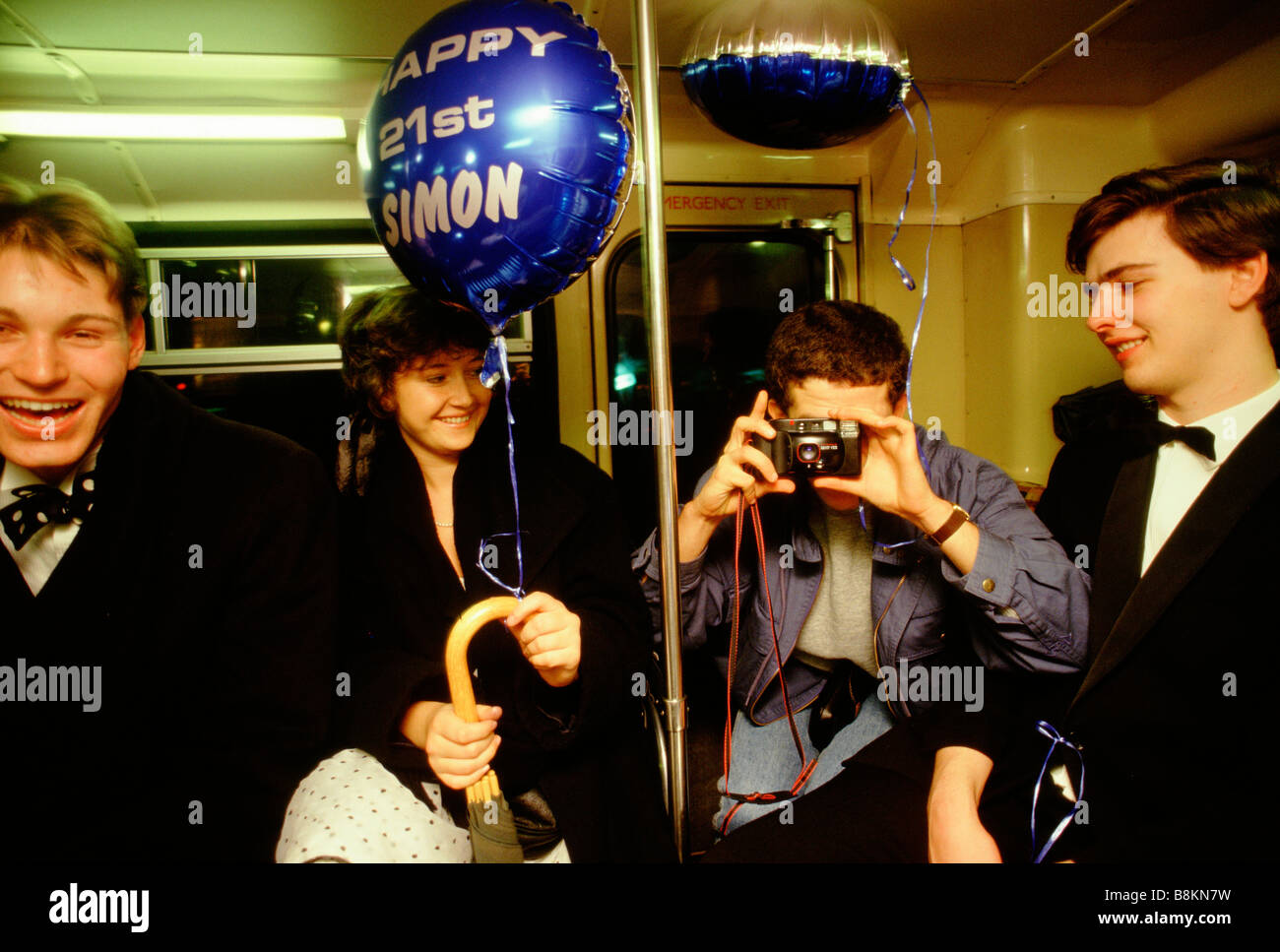 A twenty-first birthday party group travel home on a night bus, London ...