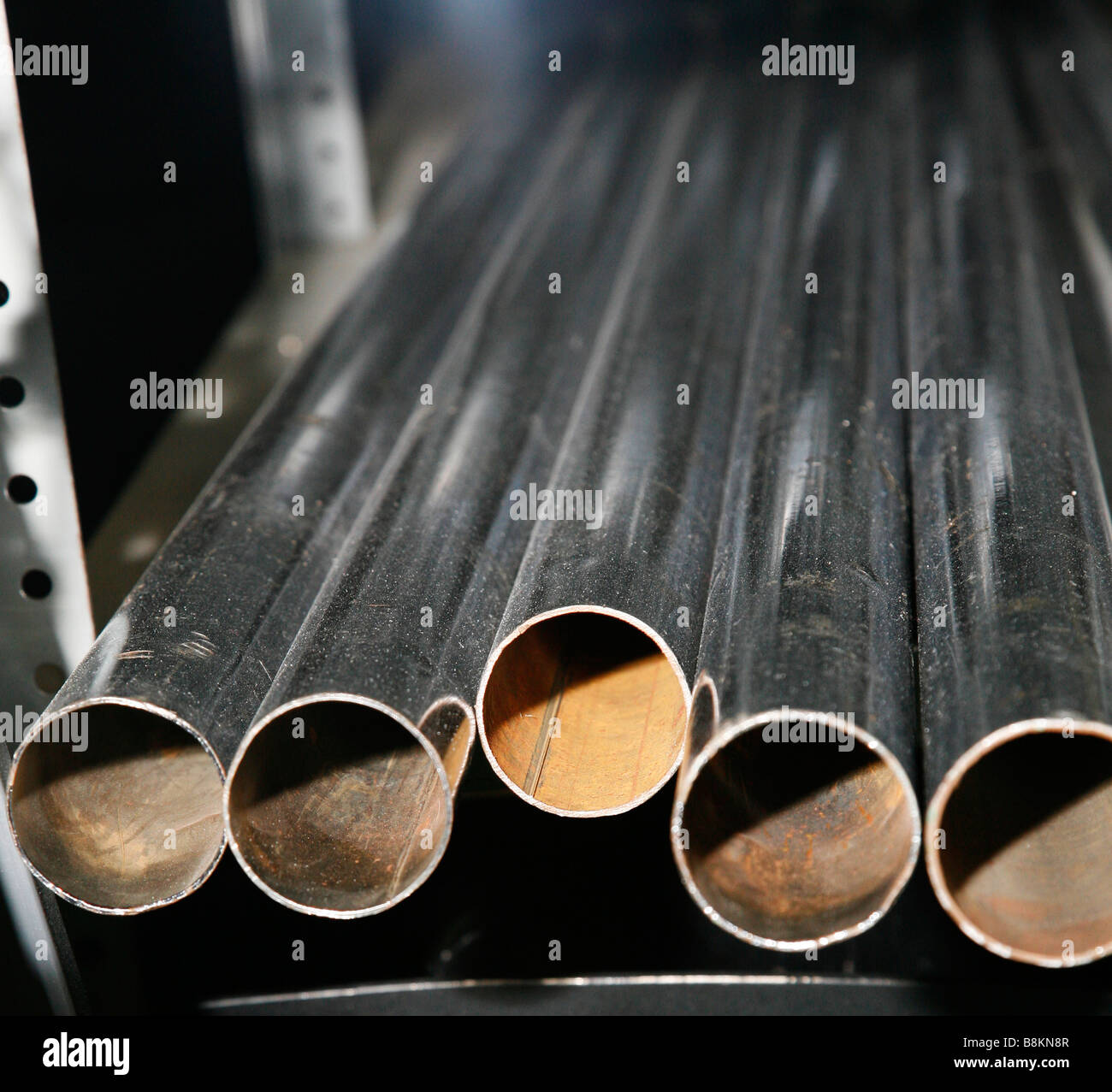 Metal tubes on a shelf in a warehouse Stock Photo - Alamy