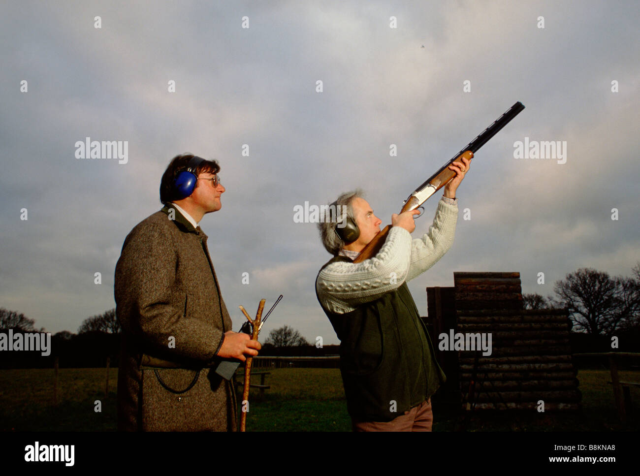 England UK : A sportsman under instruction aims at a clay with his ...