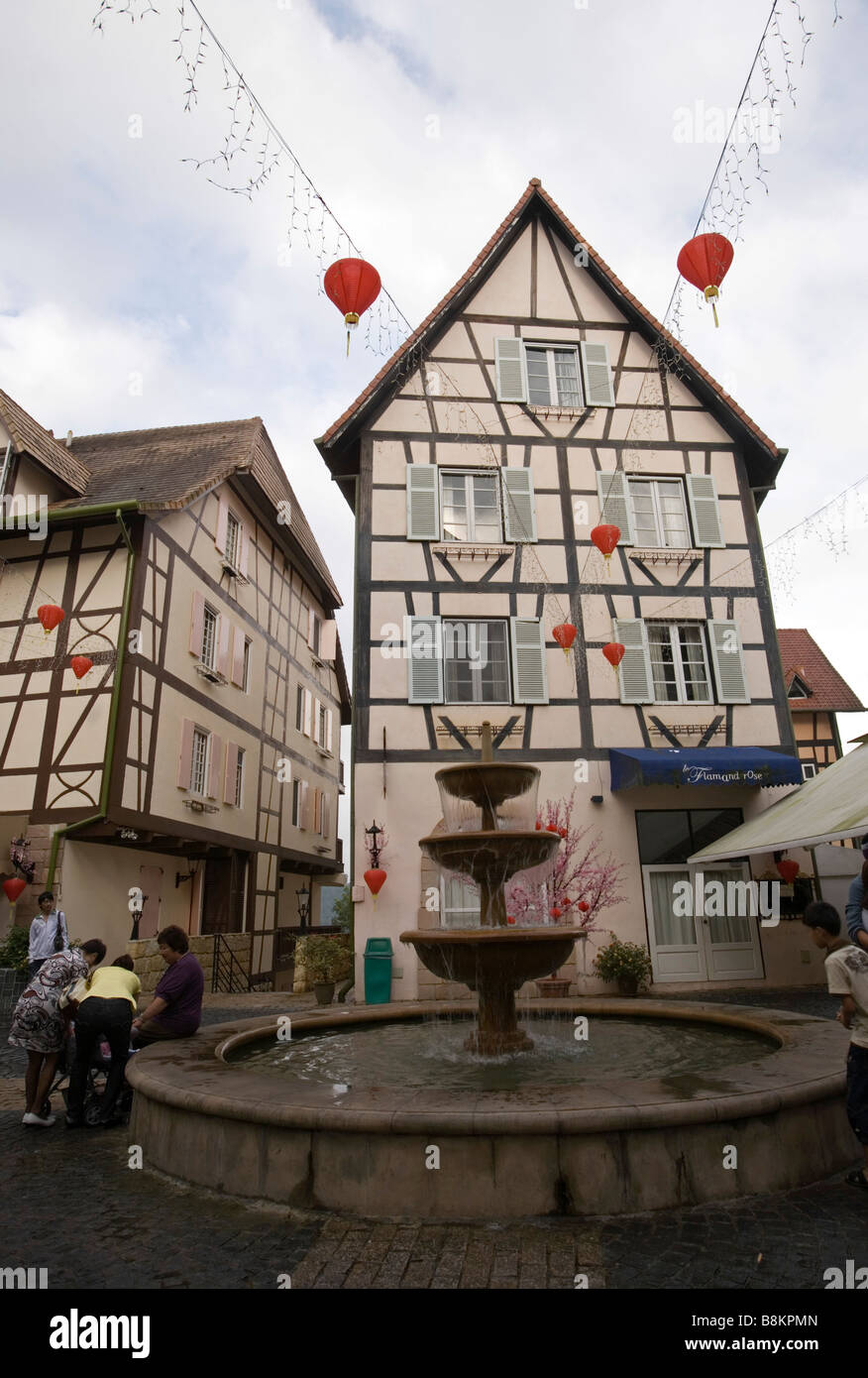 French-themed village with a fountain Stock Photo - Alamy