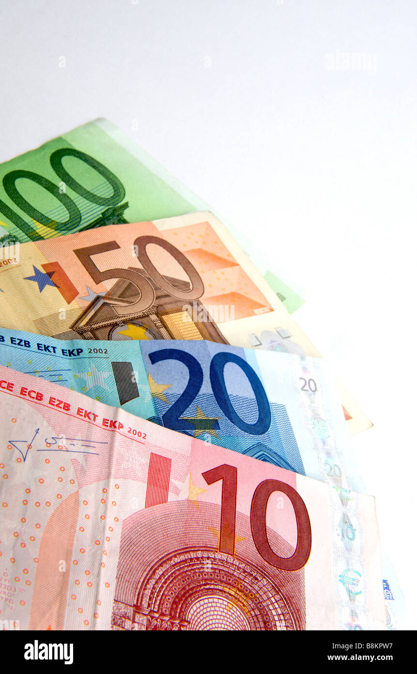 Collection of various euro banknotes displayed on a surface in a ...