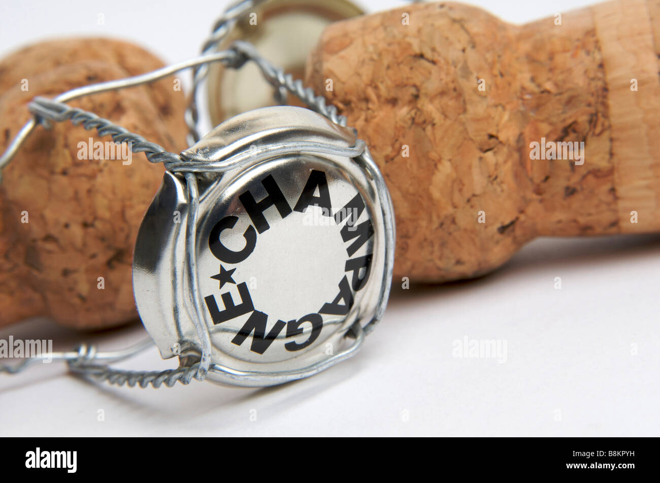 Champagne cork and wire cage captured in detail on a white background ...