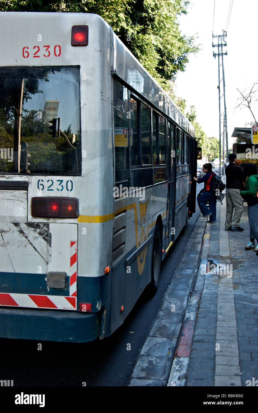 Passenger boarding diesel transit bus at bus stop Rothschild Boulevard ...