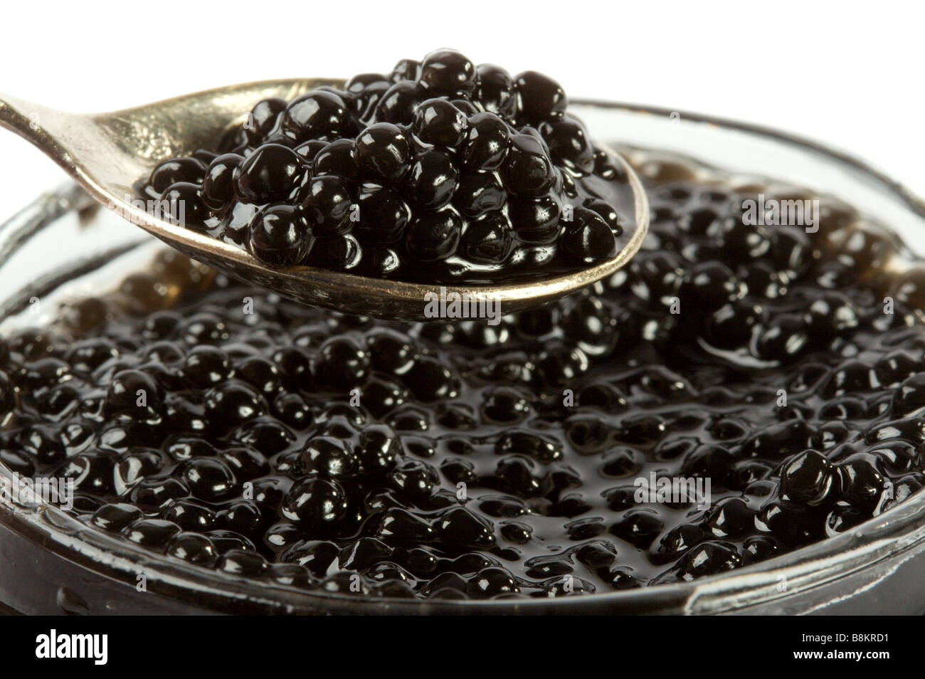 Bank with black caviar on a white background Stock Photo - Alamy