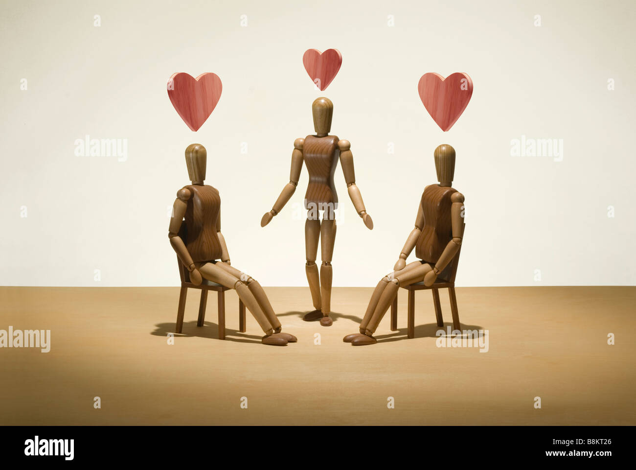 Three figures grouped together with Heart icons above Stock Photo - Alamy