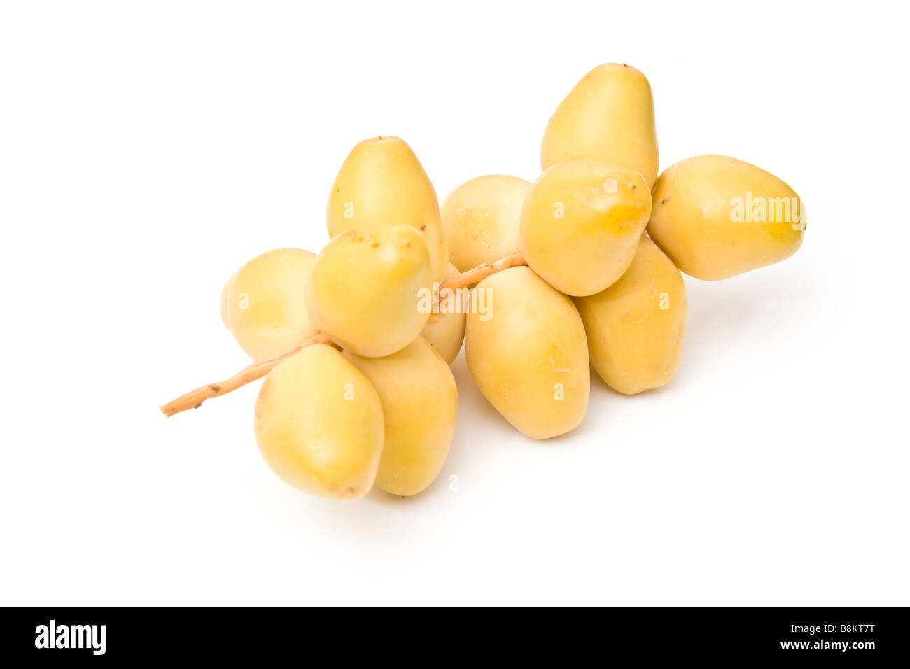Fresh yellow dates isolated on a white studio background Stock Photo ...