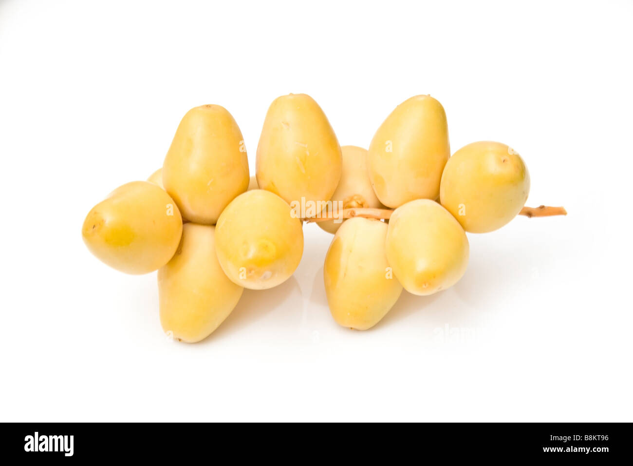 Fresh yellow dates isolated on a white studio background Stock Photo ...