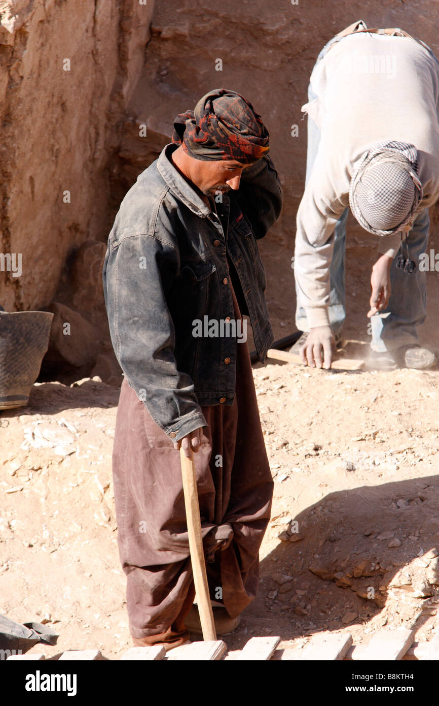 Egyptian workmen and archaeologists working on sites in the Valley of ...