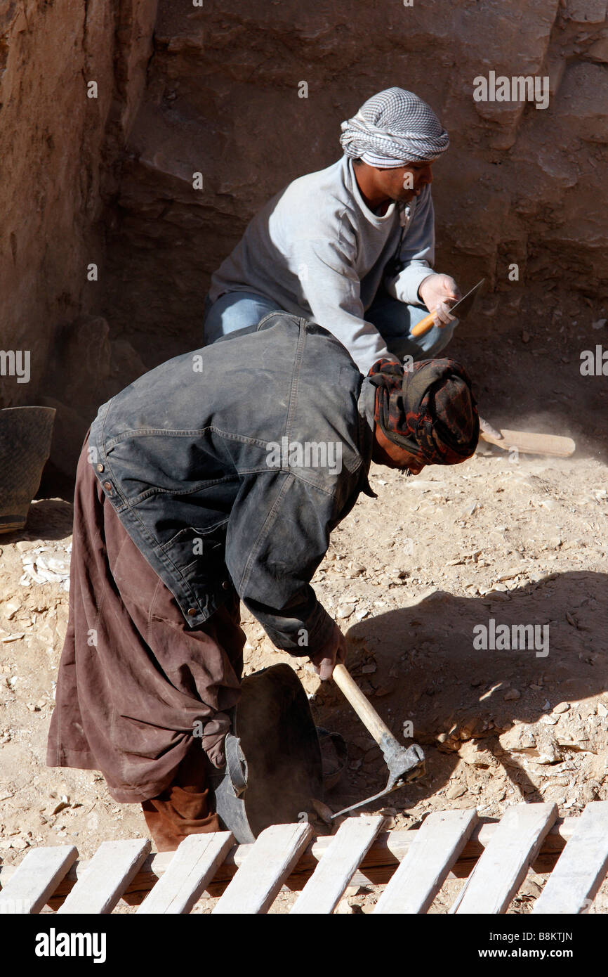 Egyptian workmen and archaeologists working on sites in the Valley of ...