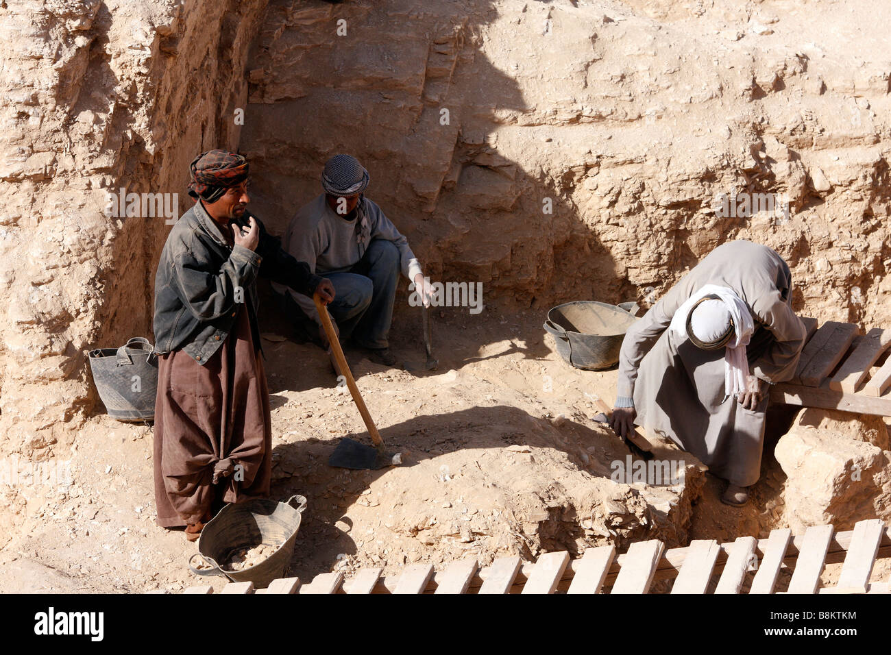 Egyptian workmen and archaeologists working on sites in the Valley of ...