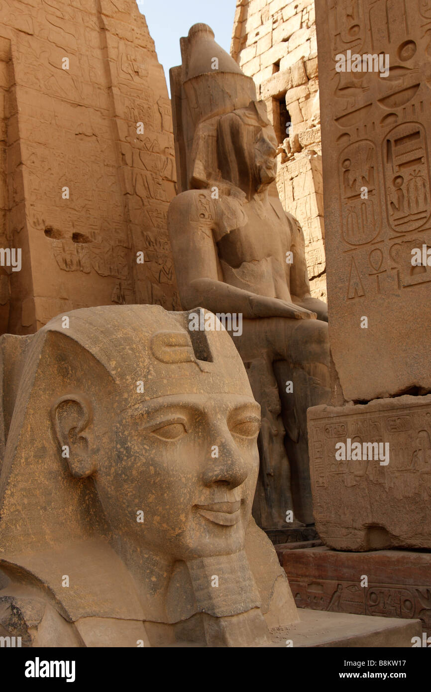 Luxor temple entrance, carved stone head of Ramses II with obelisk base ...