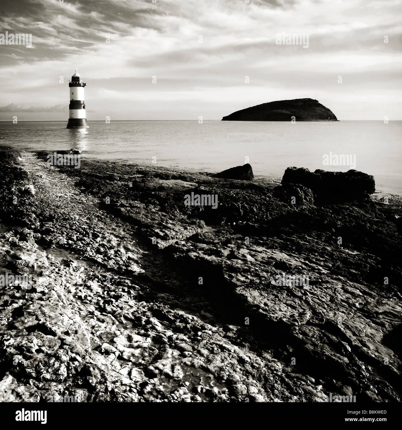 penmon lighthouse on the isle of anglesey looking over the menai straits over to puffin island ...