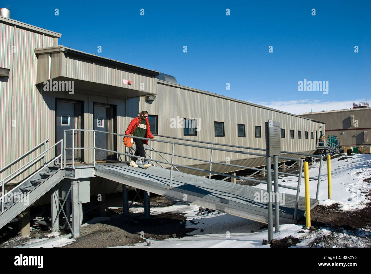 Woman exiting the Crary Science and Engineering Center, McMurdo Station ...