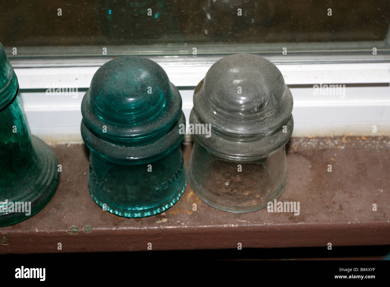 Antique green and clear glass electric insulators on windowsill Stock ...