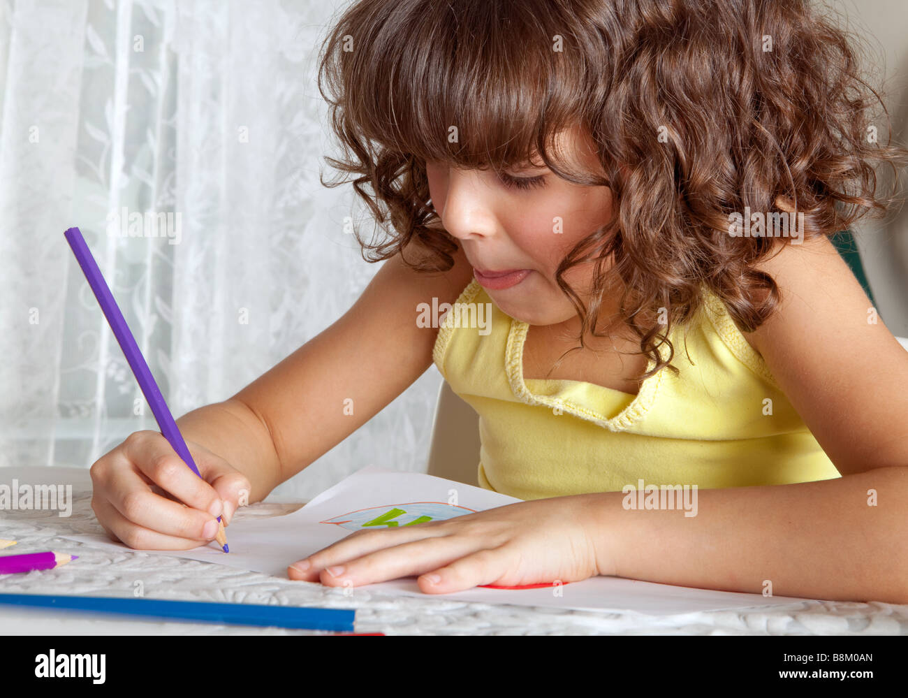 Little girl making a drawing with all her attention Stock Photo - Alamy