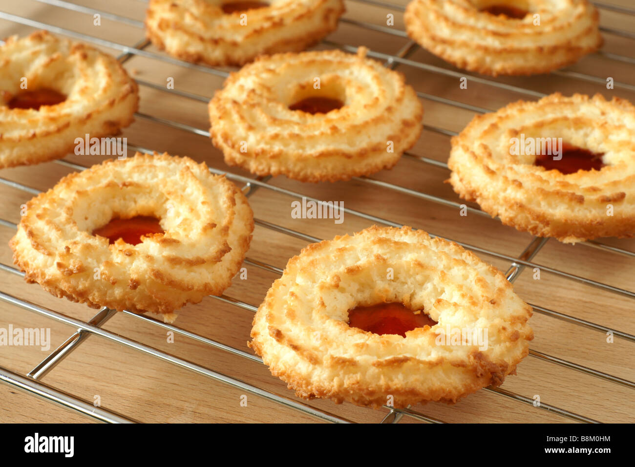 Freshly baked homemade coconut biscuits filled with jam Stock Photo - Alamy