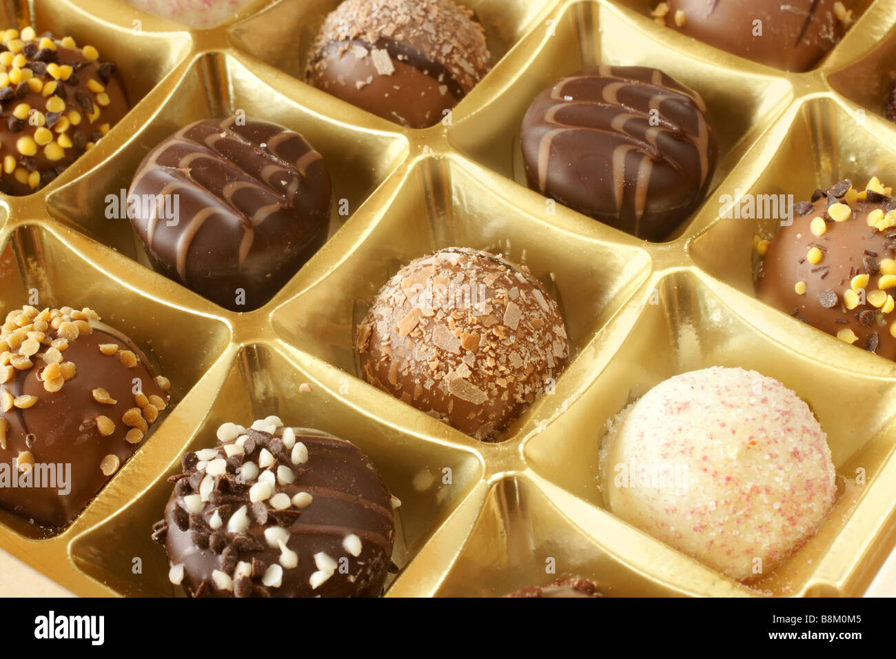 Delicious praline chocolate in a golden box Stock Photo - Alamy