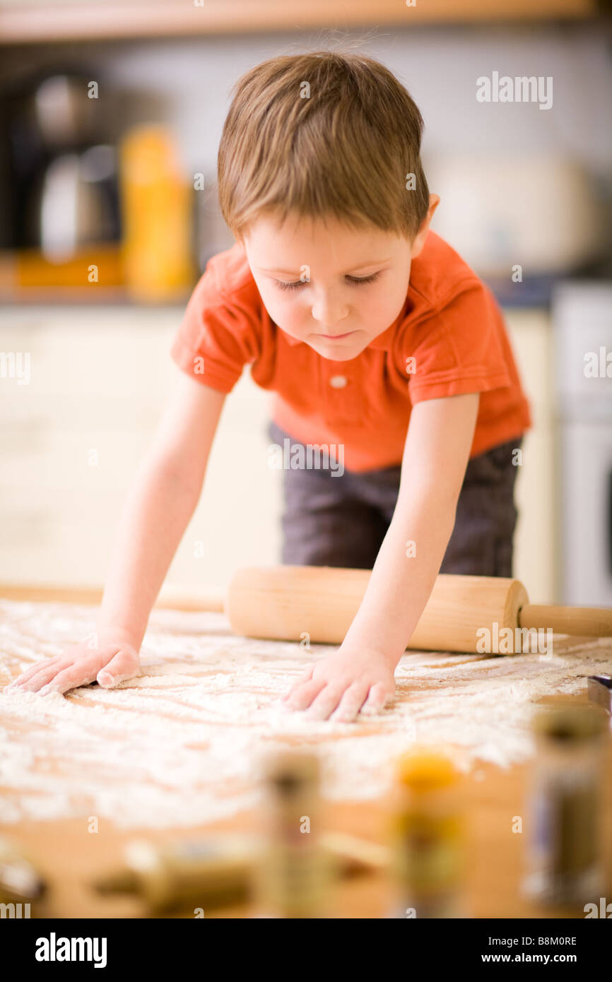 Lifestyle picture of little boy baking cookies Stock Photo - Alamy