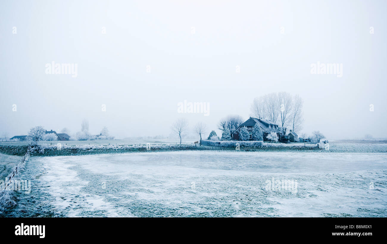 farm house in the middle of winter surrounded by frozen trees and ice ...