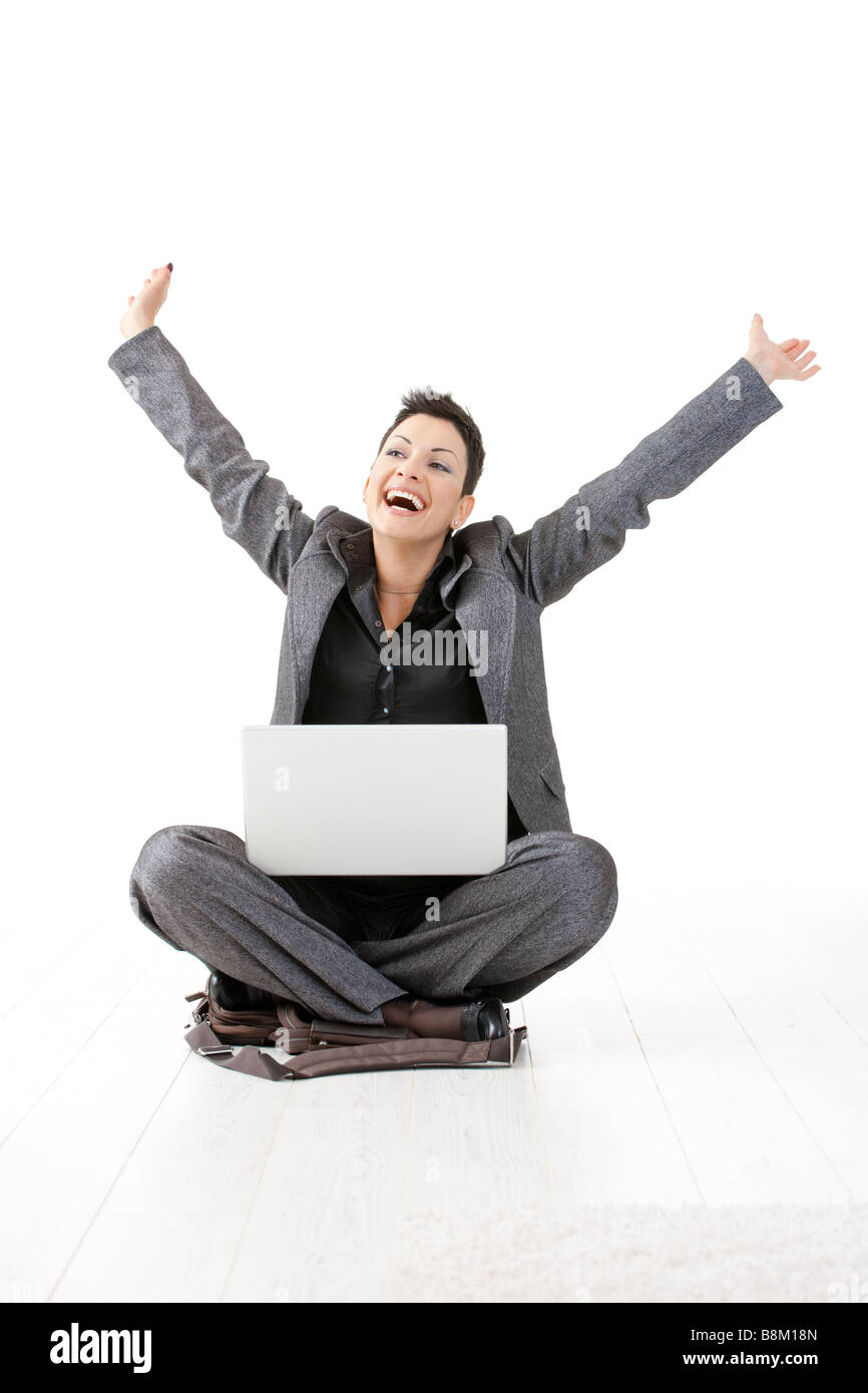 Happy businesswoman with laptop computer isolated on white background ...