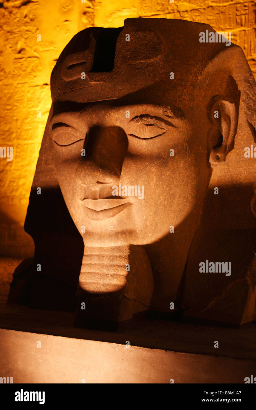 Large stone carved head of Pharaoh Ramesses II at entrance to Luxor ...