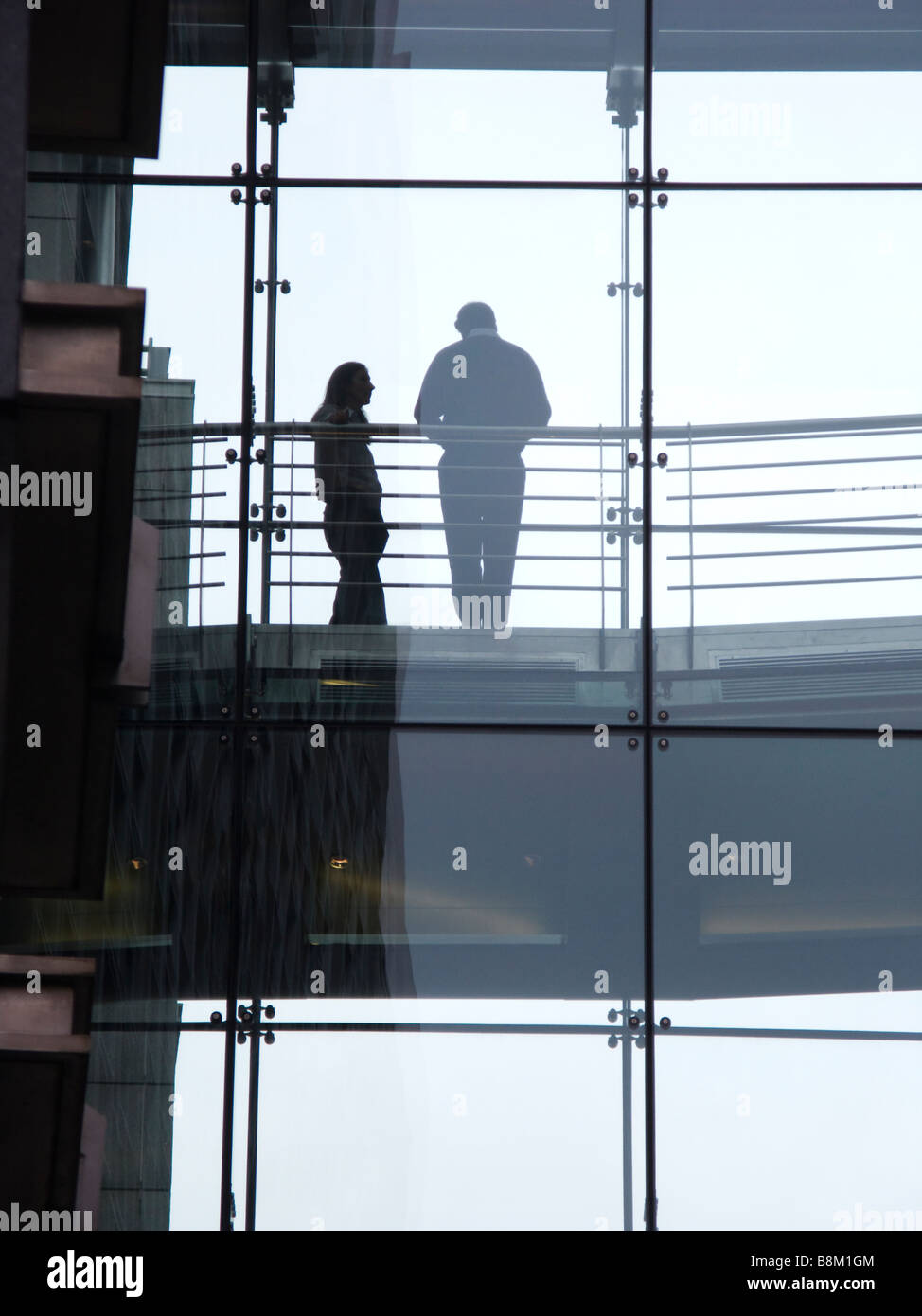 City work scene, meeting on a glazed bridge, London UK Stock Photo - Alamy