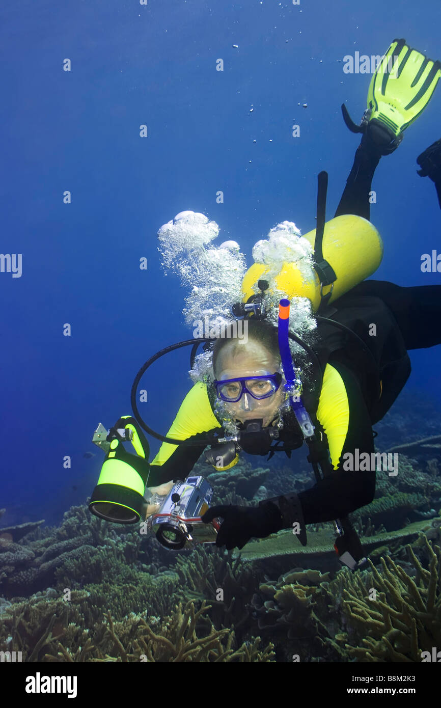 Diver with camera in deep and bubbles Stock Photo - Alamy