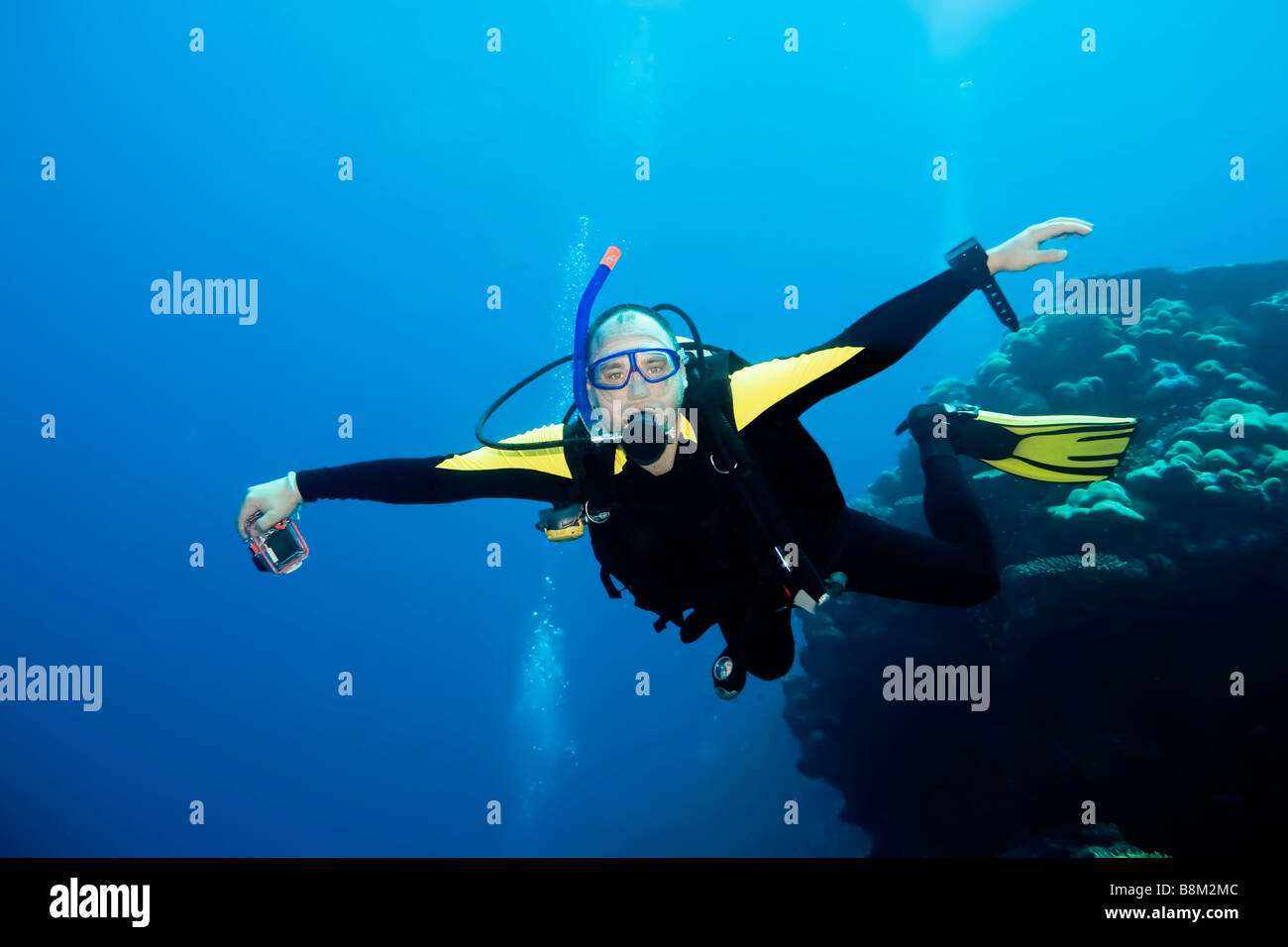 Diver flying underwater with camera Stock Photo - Alamy