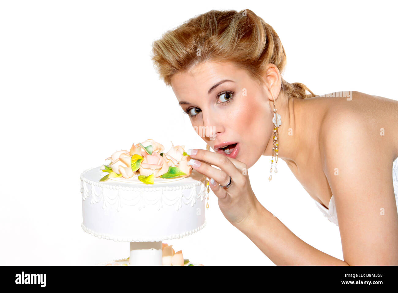 beautiful bride in white wedding dress eating cake Stock Photo - Alamy