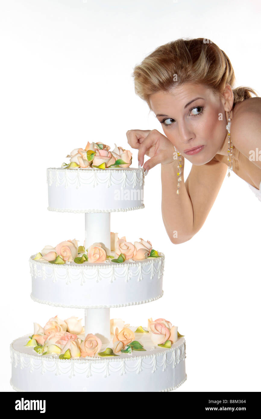 beautiful bride in white wedding dress eating cake Stock Photo - Alamy