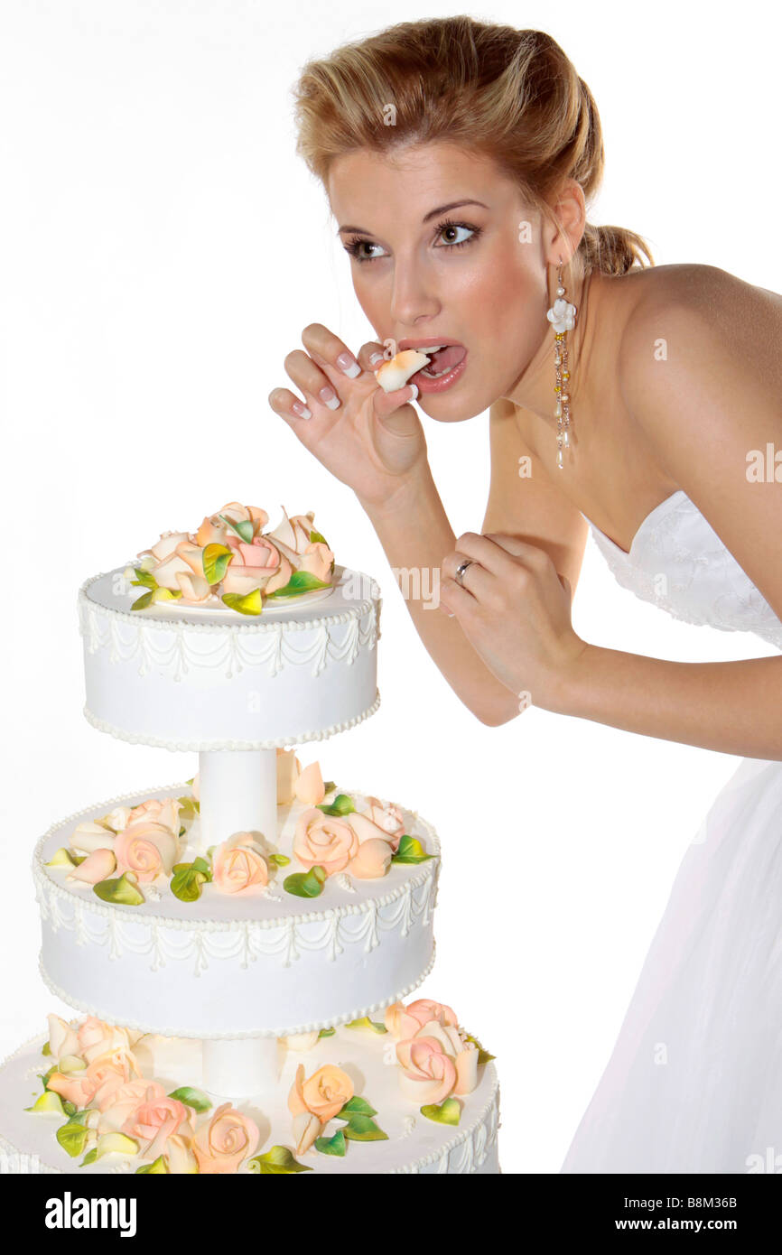 beautiful bride in white wedding dress eating cake Stock Photo - Alamy